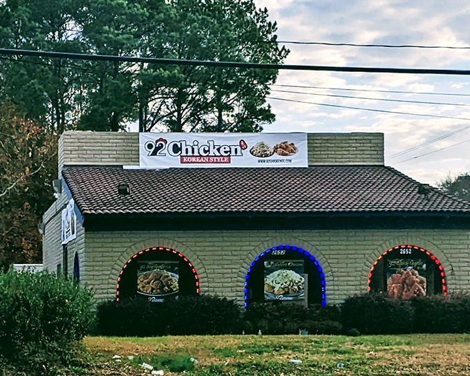 Colorful menu displays hint at the Korean-style fried chicken adventure waiting inside this unassuming green building.