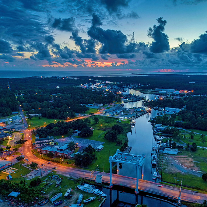 Evening light transforms Bayou La Batre into something magical, where working boats become silhouettes against painted skies.