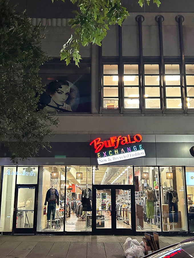 Buffalo Exchange's urban storefront glows with nighttime shopping potential. That stylish mannequin in the window hints at the fashion-forward finds inside.