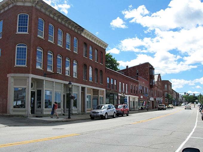 Historic brick buildings line Calais' charming Main Street, where affordable apartments can be found above local shops.