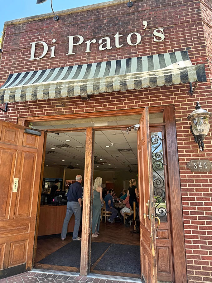 DiPrato's elegant brick exterior and striped awning promise a sophisticated sandwich experience inside.