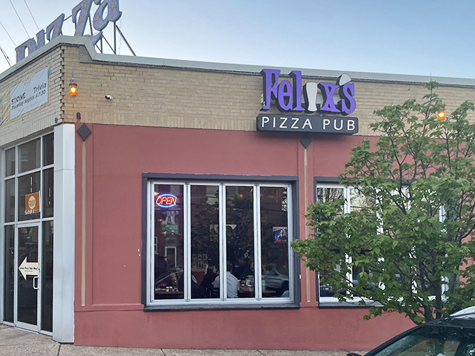 A purple sign and bold facade make Felix’s Pizza Pub stand out, promising good vibes and even better pies inside.