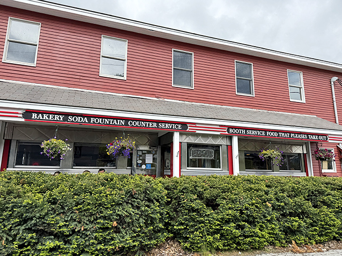 The Four Aces Diner's vibrant red siding and hanging flower baskets create the perfect backdrop for breakfast bliss.