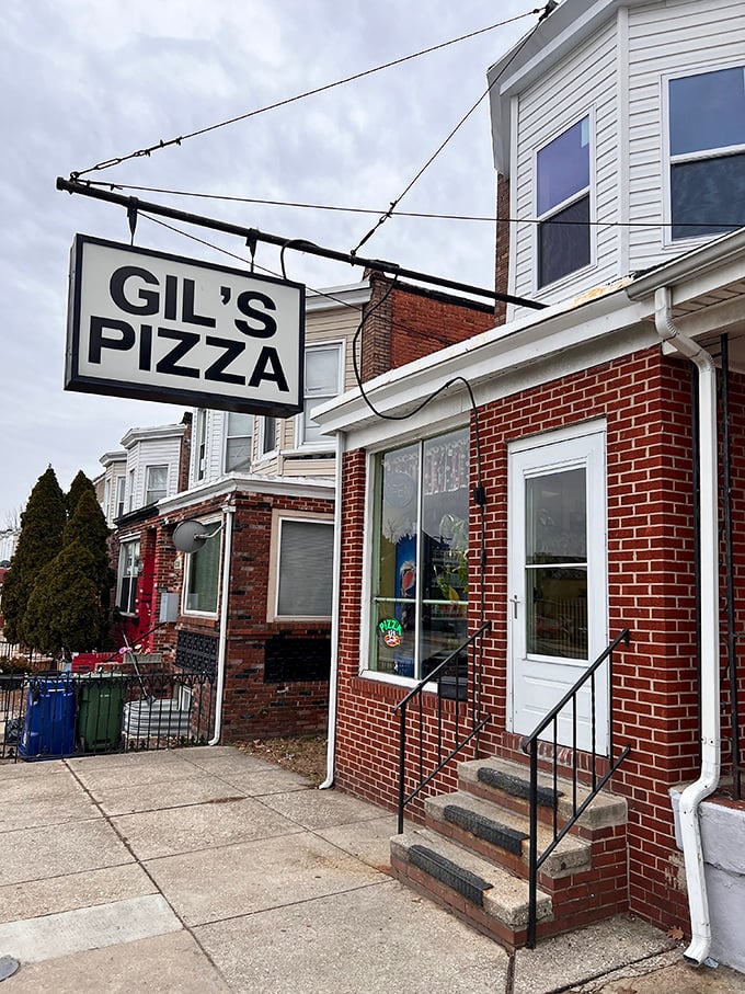 Gil's Pizza's vintage sign has pointed the way to neighborhood pizza perfection for decades.
