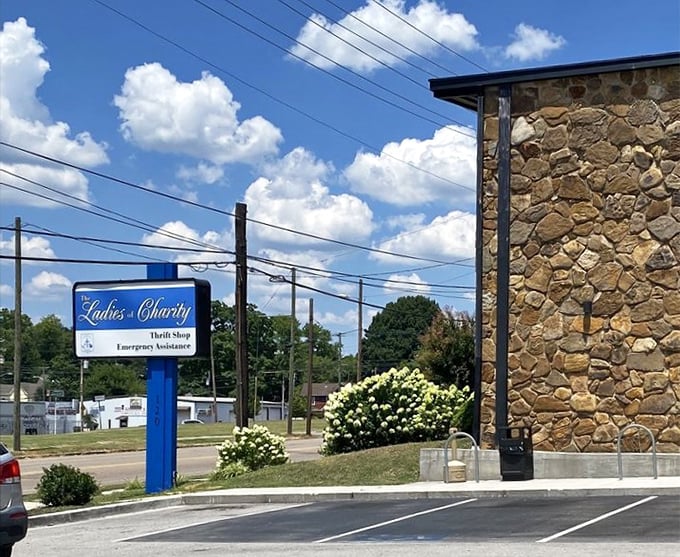 Ladies of Charity's stone facade and blue sign create an inviting atmosphere for community-minded shoppers.
