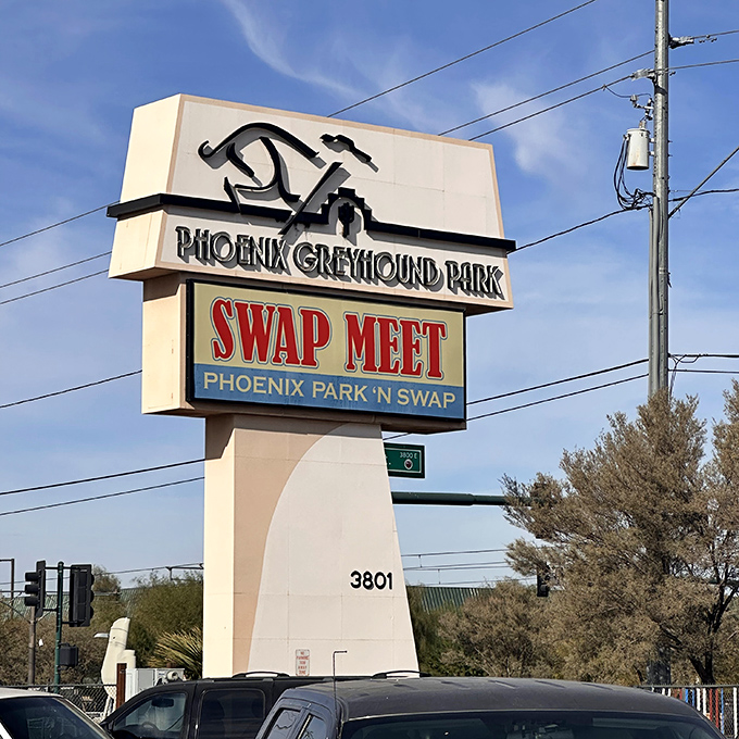 Greyhound legacy reimagined! This towering sign stands like a desert lighthouse, guiding bargain ships to safe harbor at Phoenix Park 'n Swap's asphalt shores.