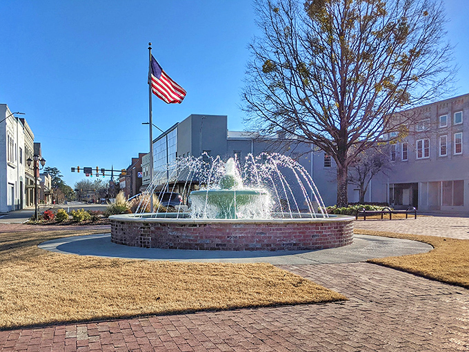 Rockingham's downtown fountain dances with water while Old Glory waves proudly overhead like a postcard.