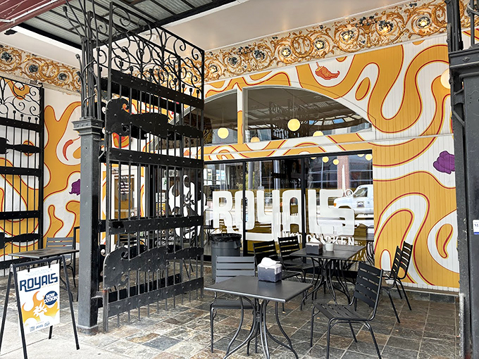 Royals' outdoor seating area invites you to linger over hot chicken. Iron gates and artistic walls set the stage for spicy indulgence.