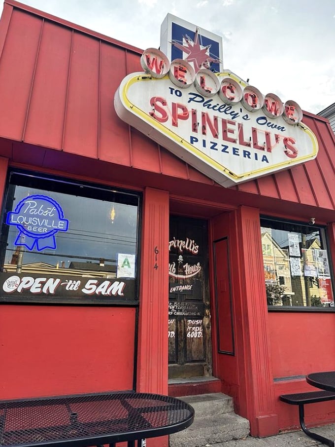 Spinelli's Vegas-style sign glows like a red-hot promise of late-night pizza salvation.