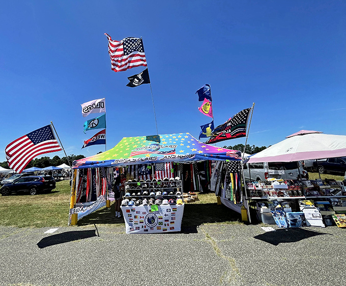 American flags flutter above vendor tents where serious collectors hunt for antiques across acres of airport grounds twice yearly.
