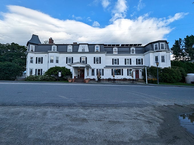 The Snowvillage Inn stands like a grand white sentinel, promising comfortable beds and breakfast views worth waking up for.