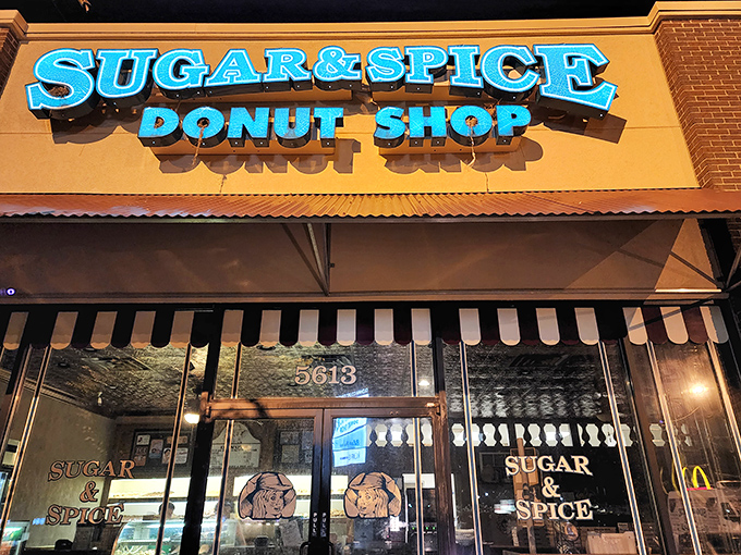 Sugar & Spice's turquoise sign pops against the striped awning, a colorful preview of the sweet magic inside.