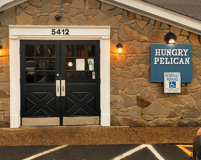 The Hungry Pelican's stone and blue exterior stands out like a coastal cottage that somehow landed in Kentucky.