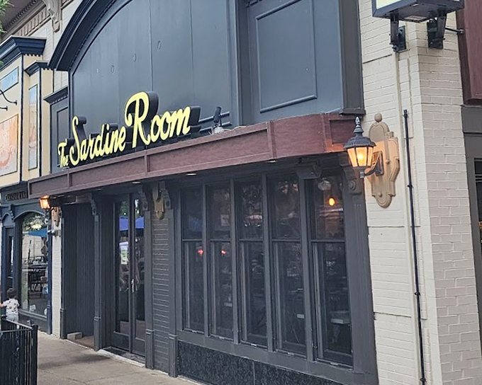 The Sardine Room's elegant gold lettering promises a seafood experience that's anything but ordinary.