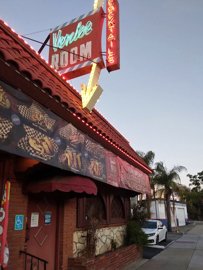The Venice Room's vintage neon sign glows like a beacon for DIY steak enthusiasts and cocktail aficionados alike.