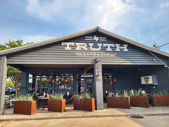 Truth BBQ's sleek black exterior stands out like a cool kid in a crowd. Modern design proves great BBQ doesn't need an old shack.