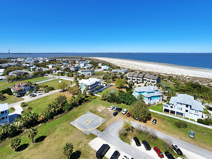 Tybee's pastel paradise from above! Beach homes cluster like colorful seashells around a helipad&mdash;because even paradise needs an emergency landing spot.