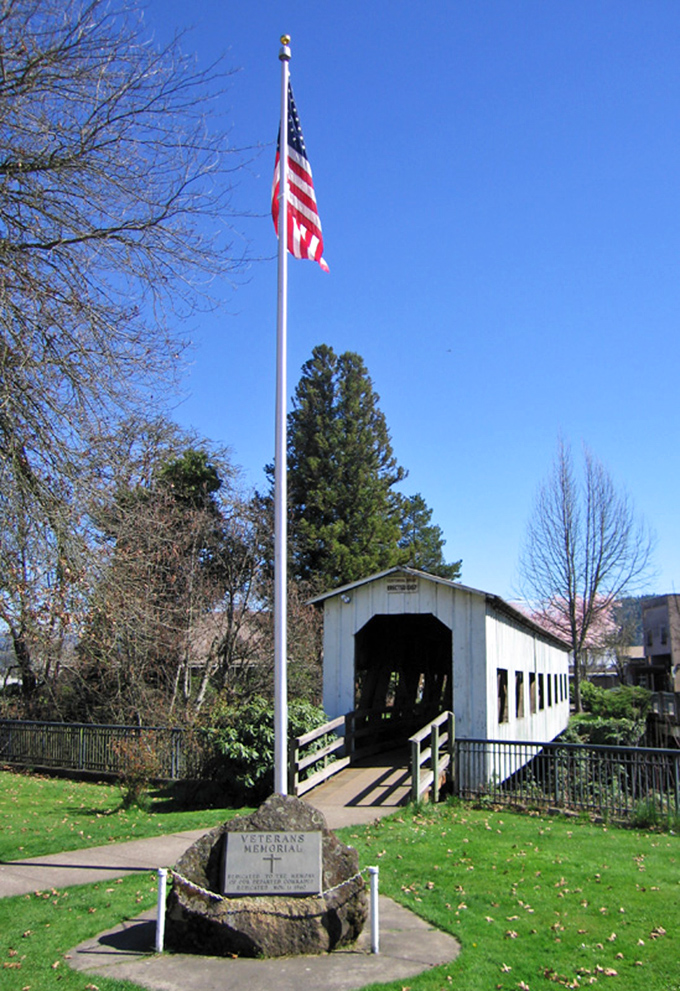 Cottage Grove's historic covered bridge stands proudly beneath Old Glory, a slice of Americana that won't drain your retirement fund.