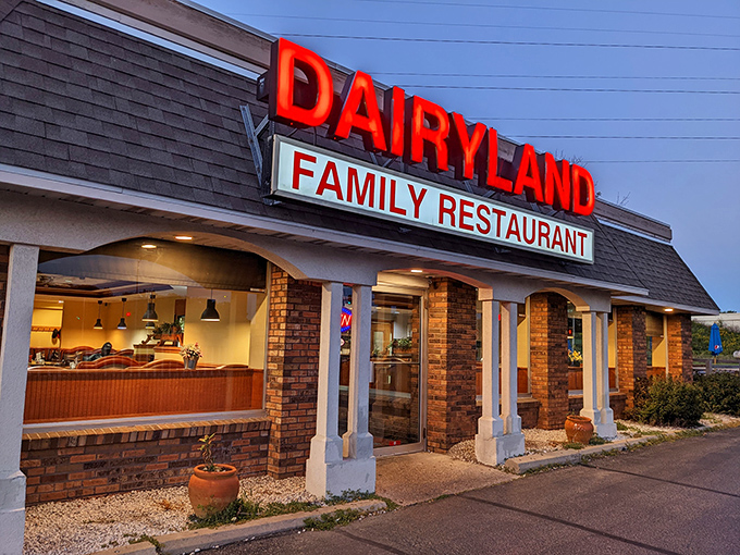 That glowing sign in the evening light—like a beacon calling all hungry travelers home.