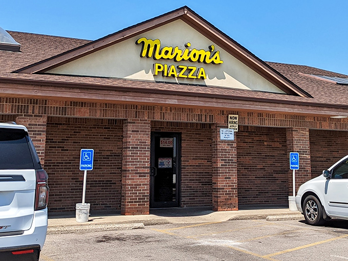 Marion's Piazza: That bright yellow sign is like a pizza lighthouse, guiding hungry travelers to square-cut slice perfection.