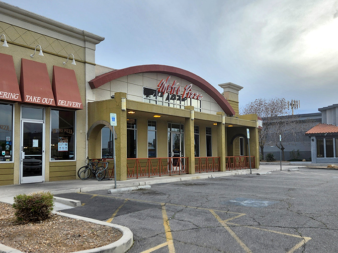 That curved red awning isn't architectural flair&mdash;it's a smile anticipating your pizza happiness.