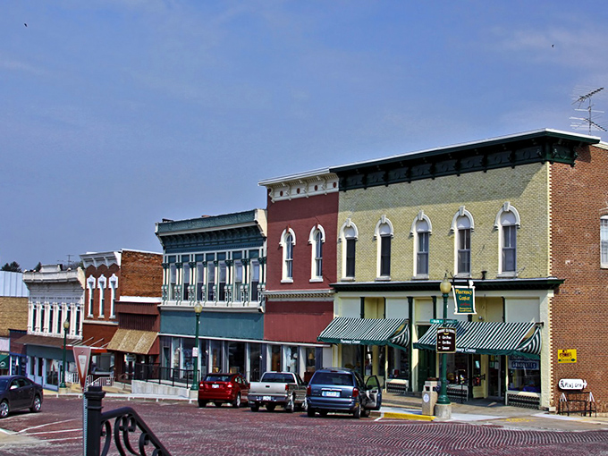 Tree-lined streets create natural cathedrals leading to the heart of authentic American small-town life.