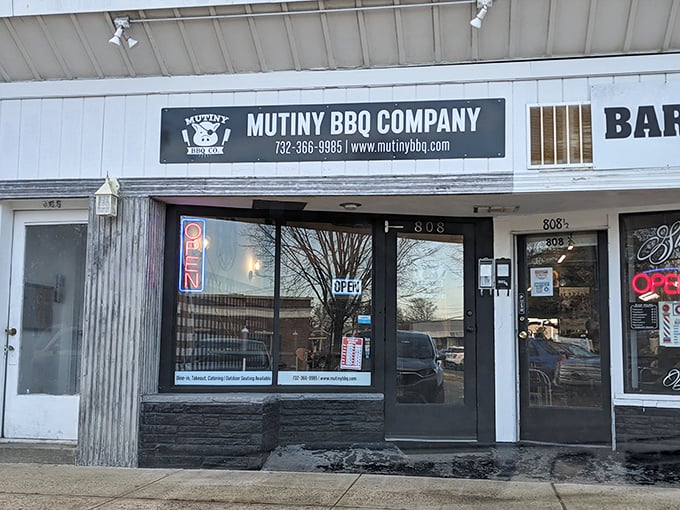 The glowing "OPEN" sign at Mutiny BBQ Company beckons BBQ lovers into their Asbury Park hideaway. Simple outside, spectacular inside.