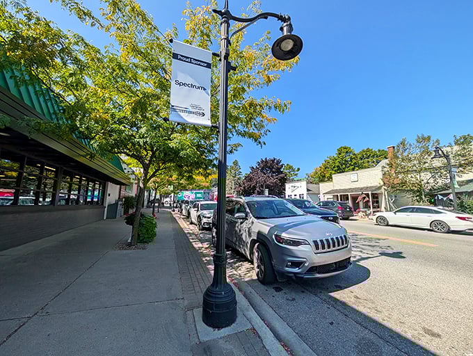 The harbor sits calm and inviting, where fishing boats rest and the water reflects the peaceful sky.