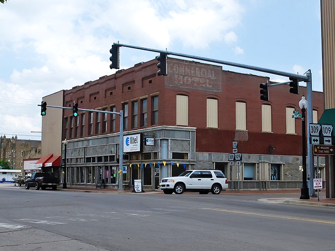 Simple brick storefronts reflect honest Arkansas values where practical meets charming on streets leading toward the state's highest peak.