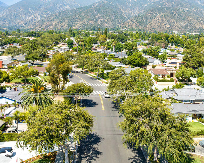 Tree-lined neighborhoods in Pasadena showcase the city's famous Craftsman homes against a backdrop of the San Gabriel Mountains.