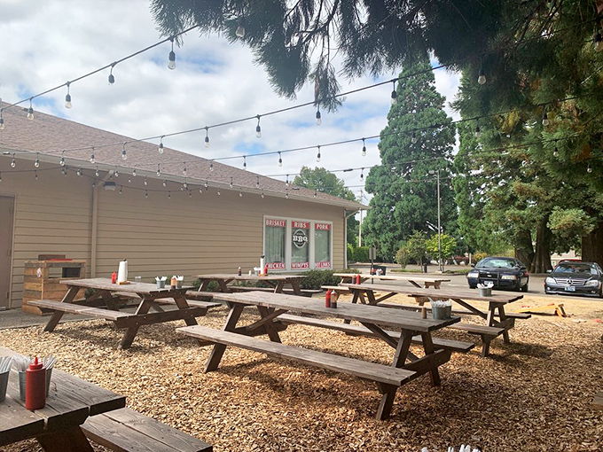 Picnic tables under string lights create the perfect BBQ atmosphere. Roger That's outdoor seating area invites you to linger over smoky treasures.