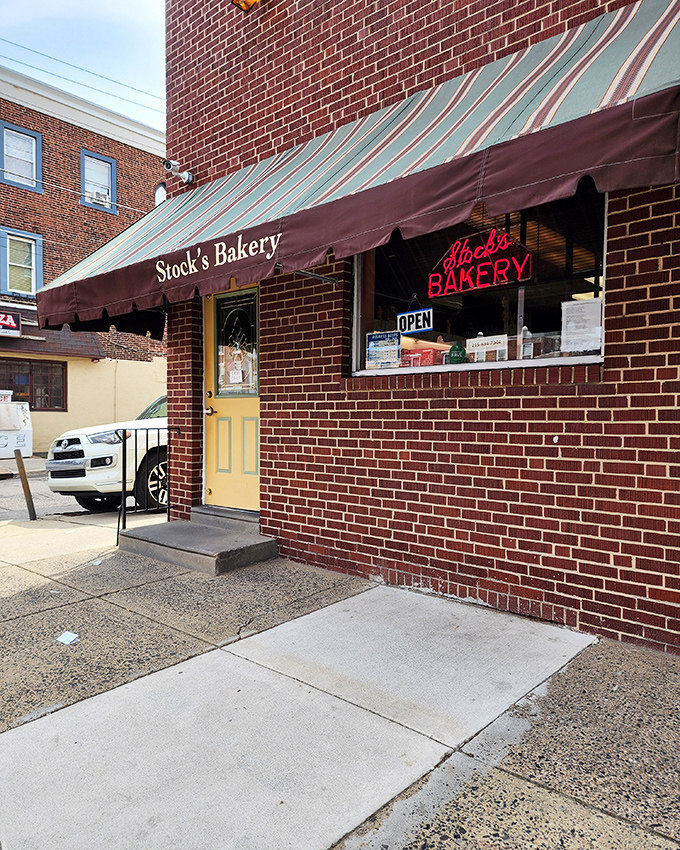 That striped awning has sheltered generations of sweet tooth satisfaction in this authentic city corner.