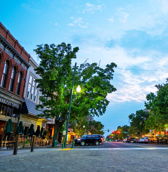 Historic downtown charm and evening lights create an inviting atmosphere perfect for leisurely strolls.