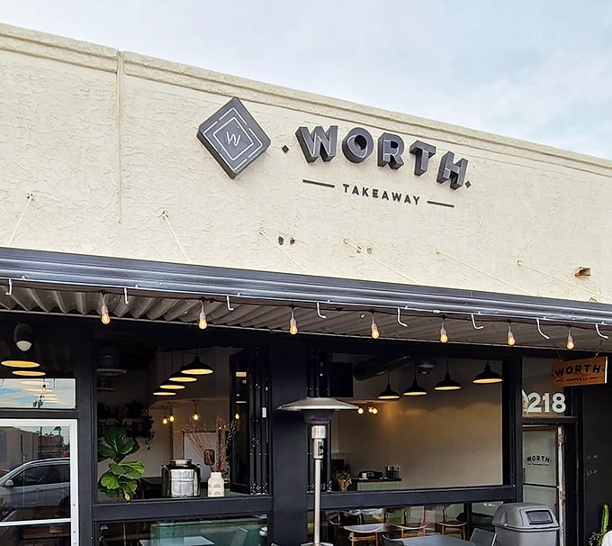 Minimalist design with garage-style windows that open wide, connecting diners to fresh air and neighborhood energy simultaneously.