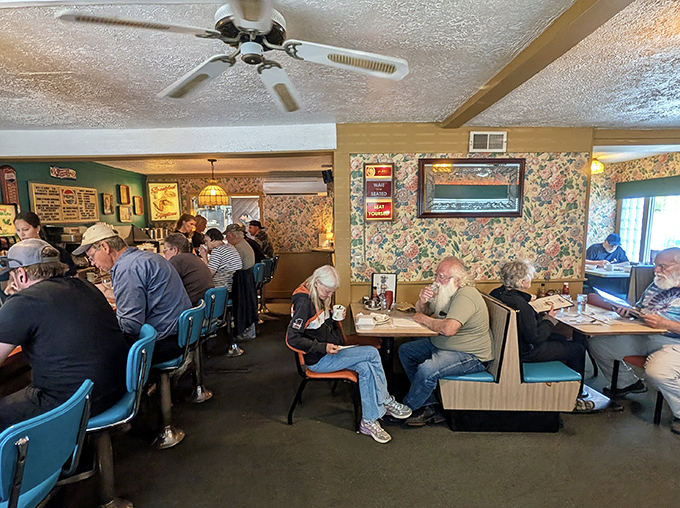 Inside Fred's, time slows down as the floral wallpaper, ceiling fans, and blue chairs create that perfect diner atmosphere where conversations flow as freely as the coffee.