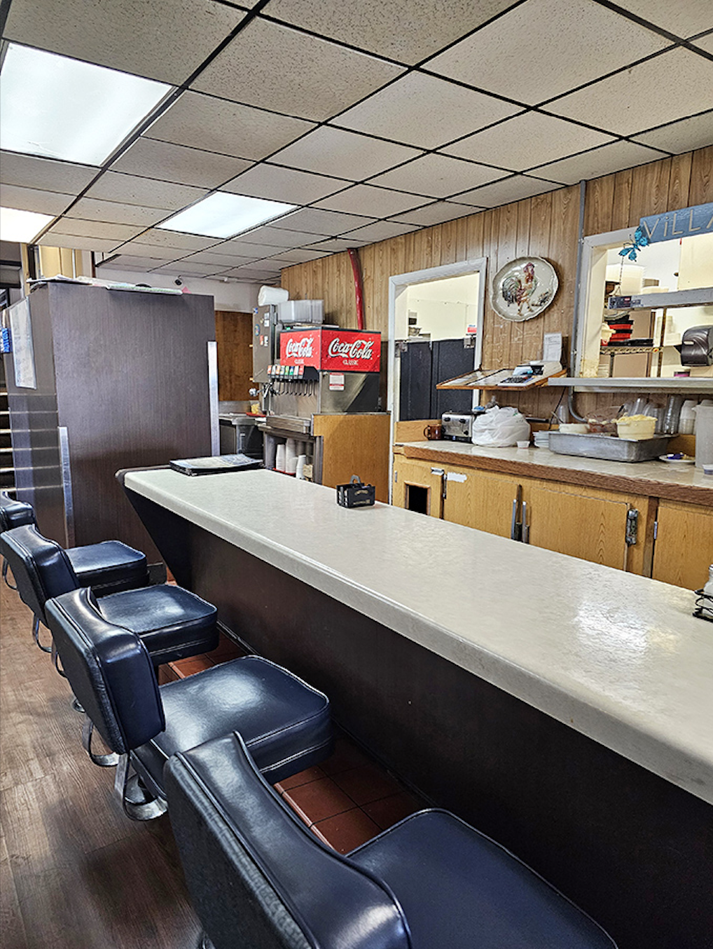 Cozy booths framed by local artwork depicting Tehachapi's famous wind farms—a reminder of exactly where in the world you're enjoying this meal.