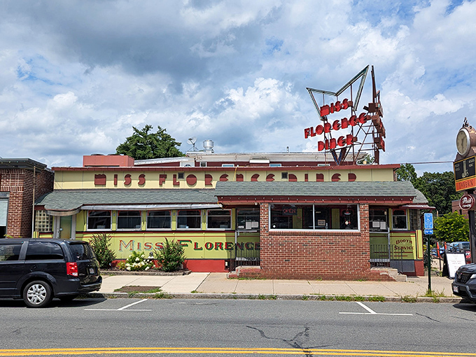 The iconic yellow exterior of Miss Florence Diner stands proudly on Main Street, its vintage neon sign a beacon for hungry travelers seeking authentic Americana.