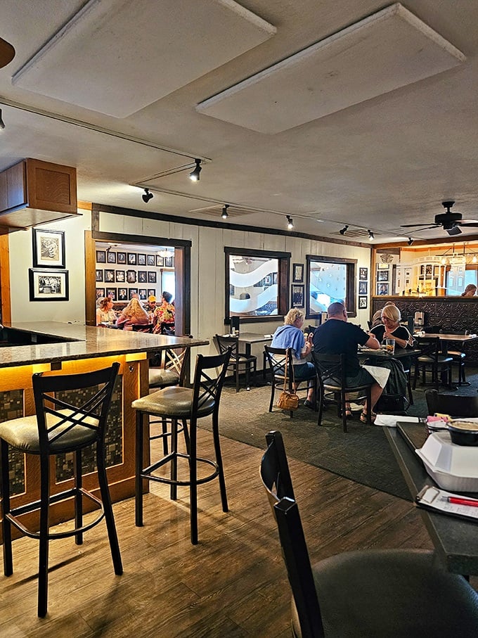 Inside, wooden floors that have supported decades of satisfied diners lead to cozy dining spaces where conversations flow as freely as the drinks. 