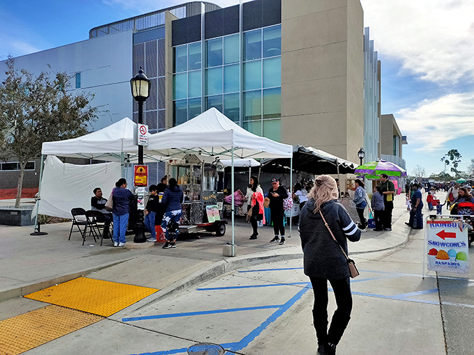 White tents spring to life against Huntington Beach's modern backdrop, transforming ordinary pavement into a treasure hunter's paradise every weekend.
