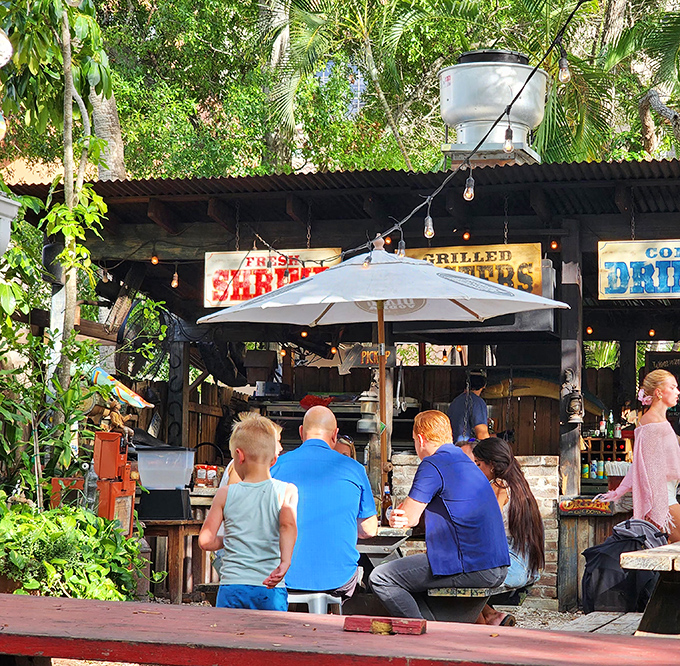 Owen's Fish Camp's outdoor bar area feels like stumbling upon a secret garden party where seafood is the guest of honor.