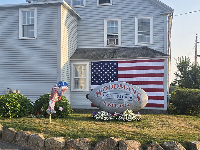The iconic Woodman's stone marker stands proudly against a backdrop of Americana&mdash;where seafood pilgrims have been worshipping at the altar of fried clams since 1914.