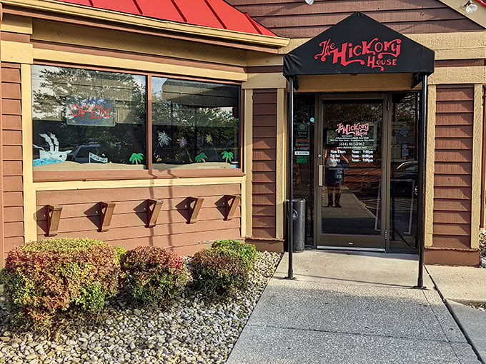 The welcoming facade of Hickory House beckons with its rustic charm and distinctive red roof accent&mdash;like a cabin retreat that happens to serve incredible steaks.