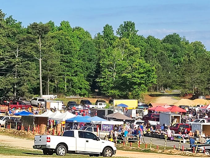 The ultimate Sunday treasure hunt unfolds beneath Alabama skies. Rows of colorful tents and eager shoppers create a bazaar worthy of an adventure movie opening scene.
