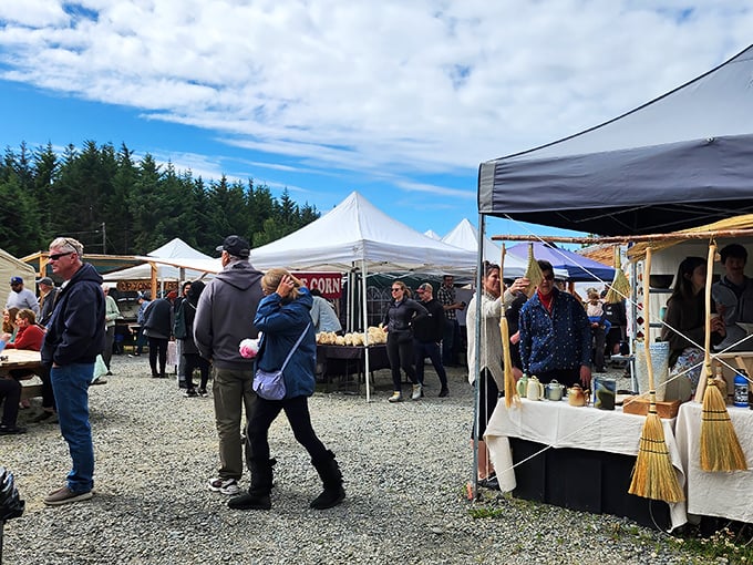 The weekend pilgrimage begins! Locals and visitors mingle under white tents at Homer Farmers Market, where Alaska's bounty is displayed with pride and friendly conversation.