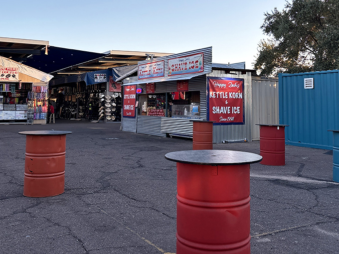 Red barrel tables dot the landscape like industrial art installations, perfect for resting your treasures or enjoying that elote you couldn't resist.