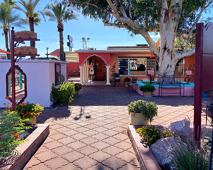 The entrance to Govinda's feels like stepping into a secret garden oasis, where salmon-colored walls and vibrant flowers welcome you to a spiritual feast.