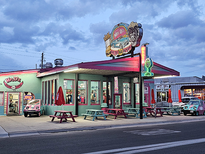 The teal and pink facade of Mr. D'z isn't just eye-catching&mdash;it's practically a time machine with a neon sign. Classic cars complete this perfect Route 66 postcard.