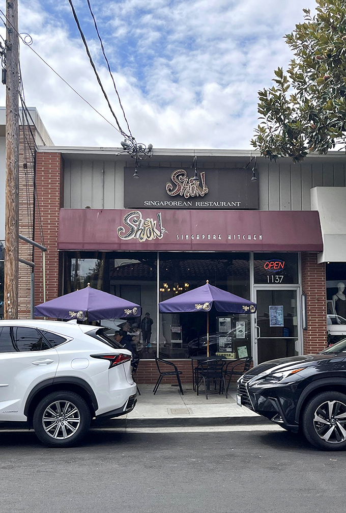 The unassuming storefront with its burgundy awning hides culinary treasures within &ndash; like finding a secret passage to Singapore on a quiet Redwood City street.