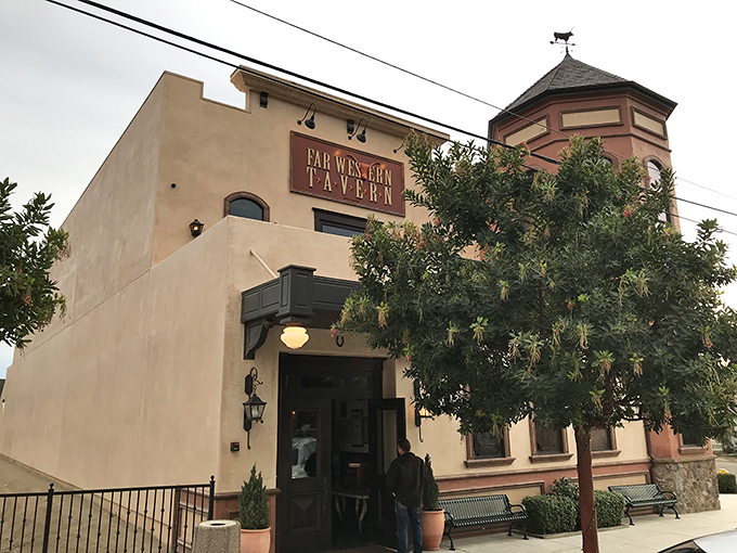 The rustic beige facade and vintage sign set the scene, while the tavern&rsquo;s turret stands like a sentinel over the ranch-inspired dishes within.