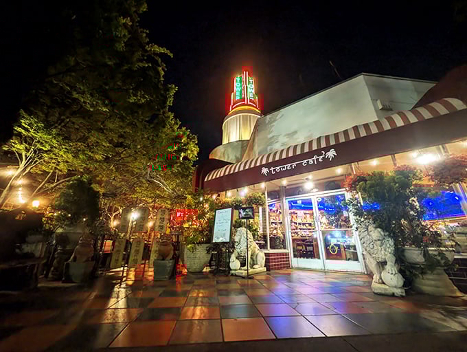 Tower Café glows like a beacon at night, its iconic neon sign and guardian statues welcoming hungry pilgrims to this Sacramento culinary sanctuary.